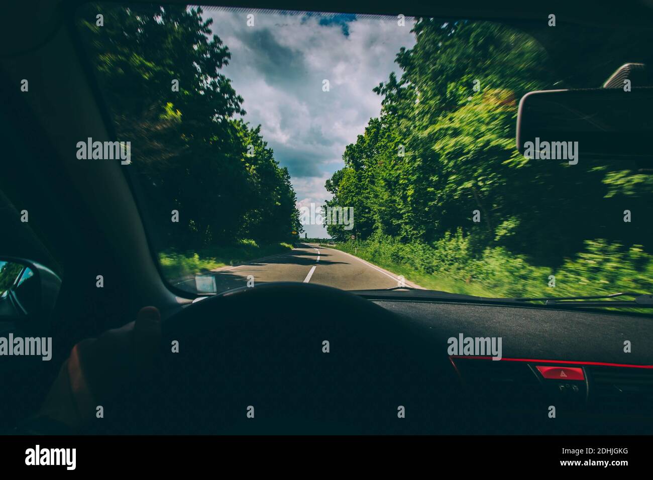 A view of the road through the front window of the car Stock Photo - Alamy