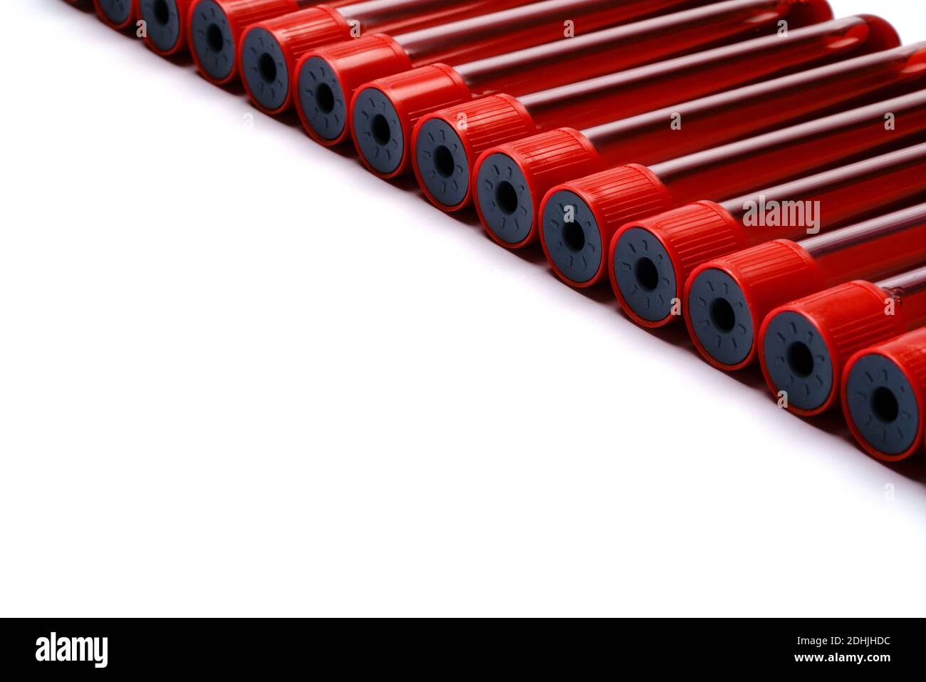 Test tubes with red plug isolated on white background Stock Photo - Alamy
