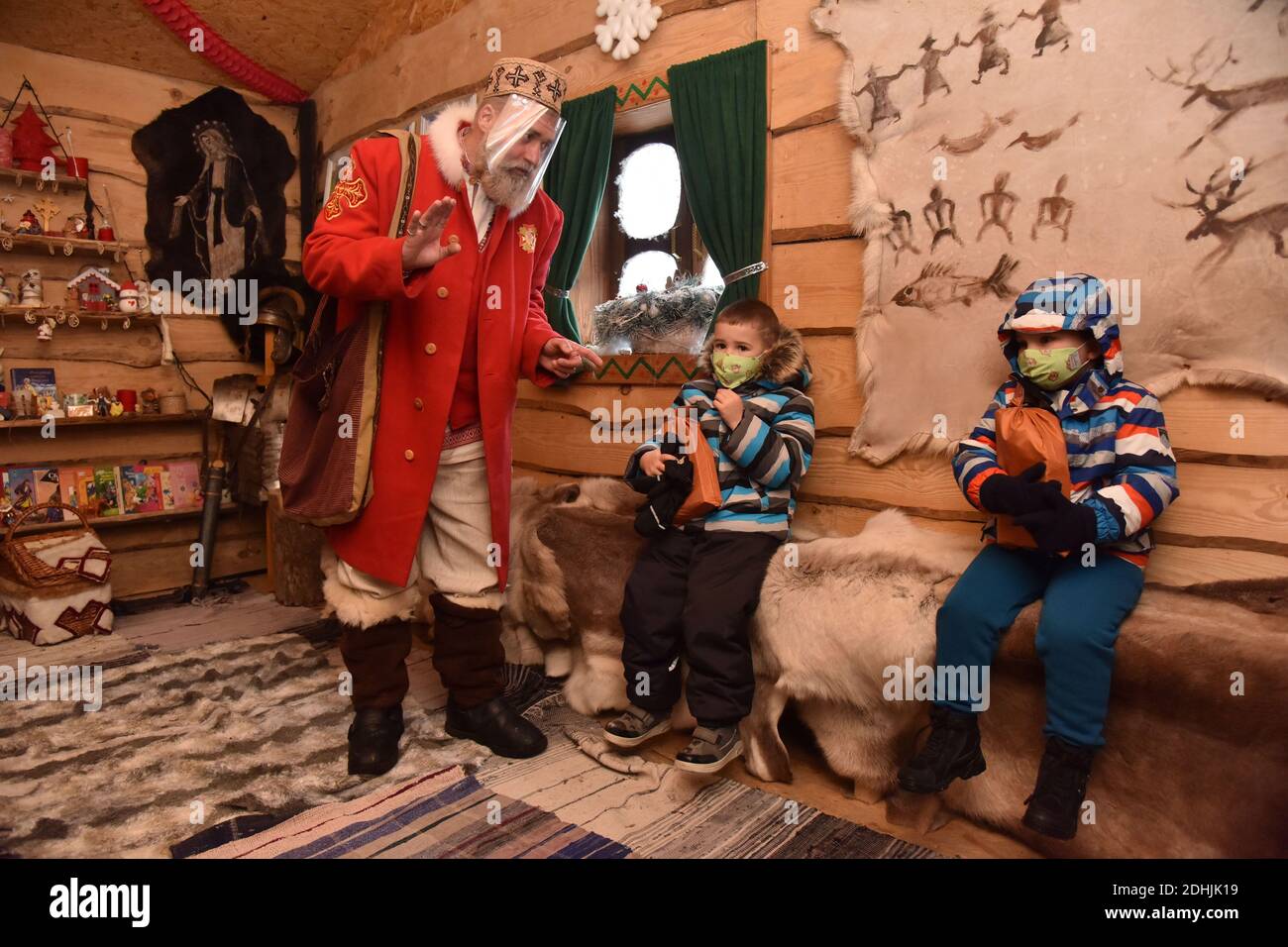An actor dressed like St. Nicholas wearing a face shield as a ...
