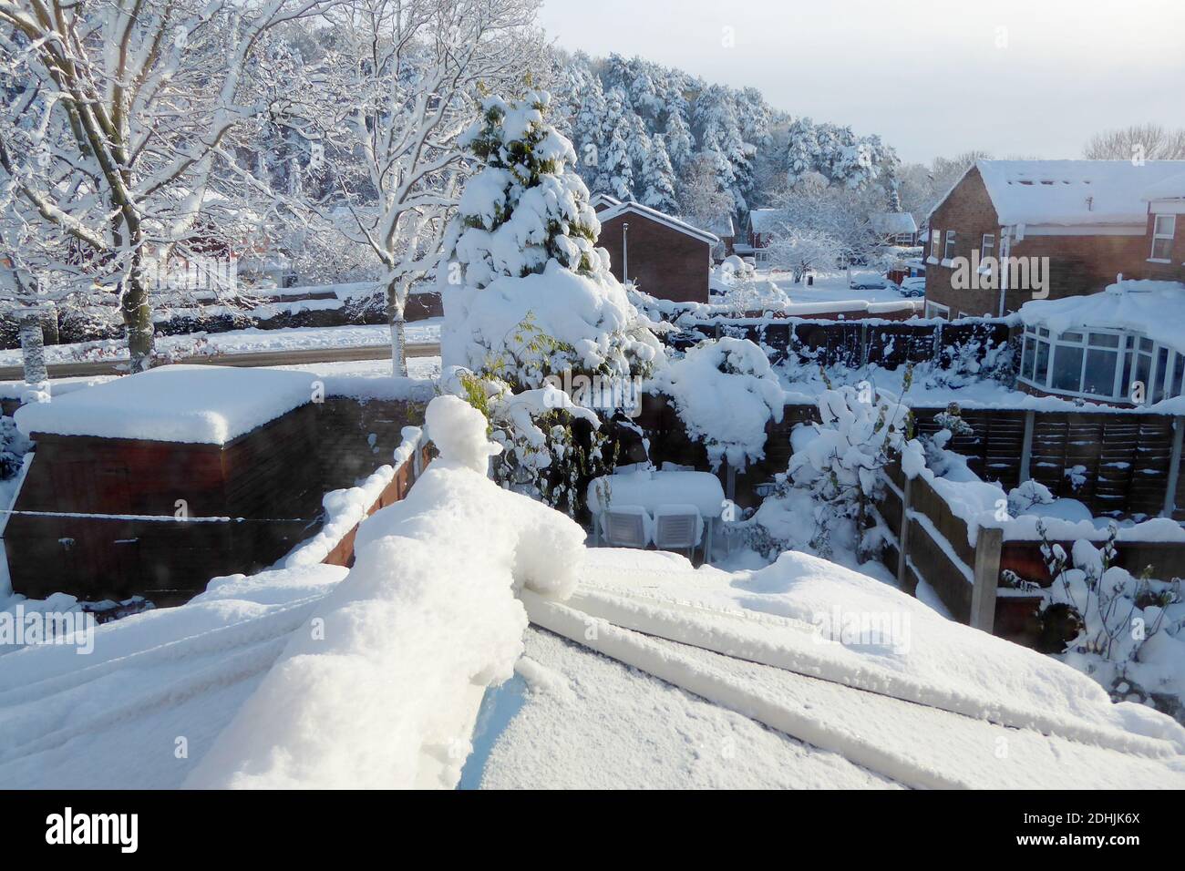 close up of snow covered conservatory roof, through window. rooftops ...