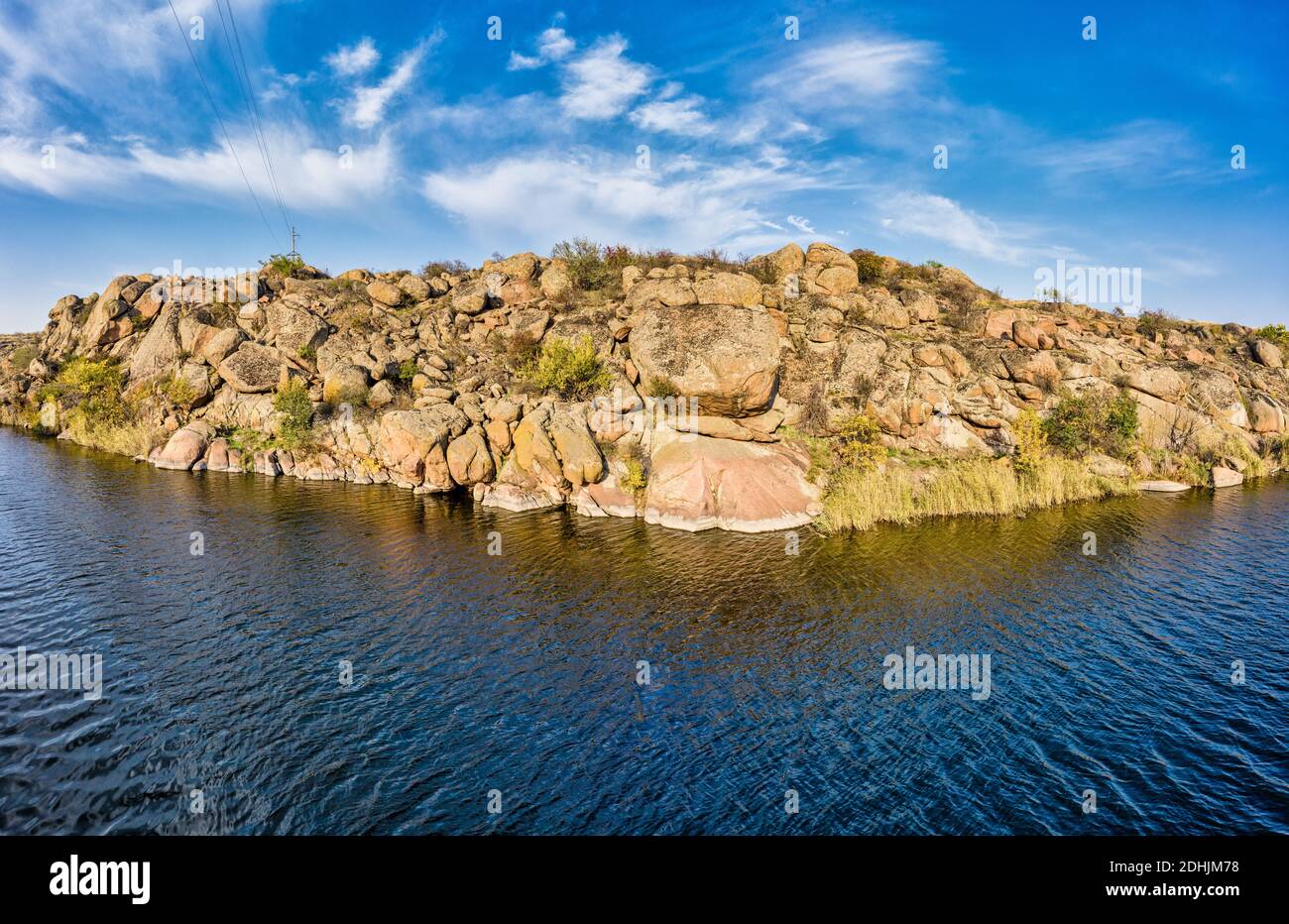 Among the large boulders, a smooth shining stream flows in the evening ...