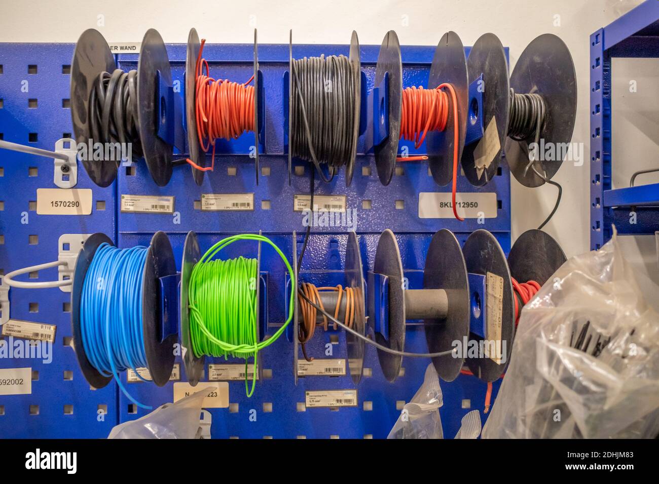 various cables are on reels in a car workshop Stock Photo - Alamy
