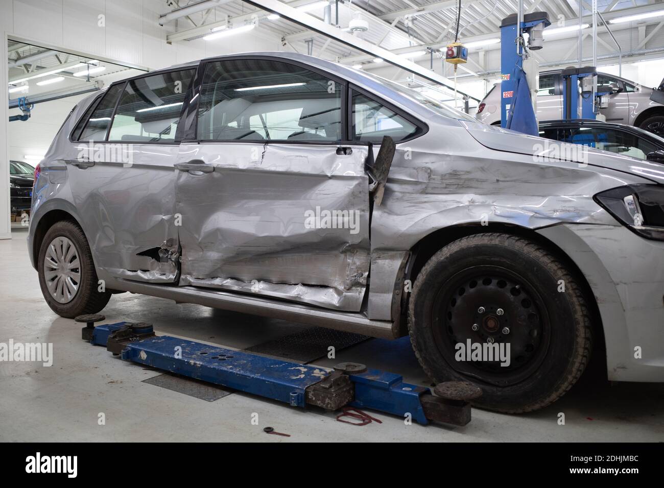 a demolished car stands in a garage after an accident Stock Photo - Alamy