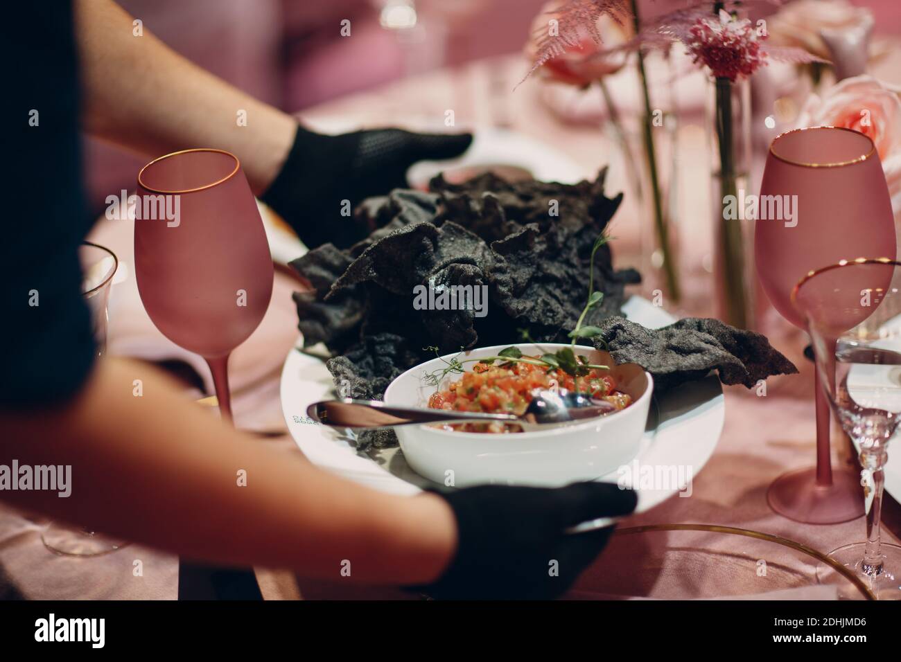 Waiter serving food for presentation to the client. Food stylist decor ...