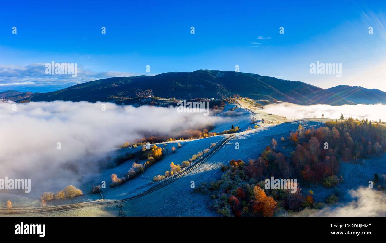 Autumn flight through blue sky in Carpatian autumn mountains, Aerial ...