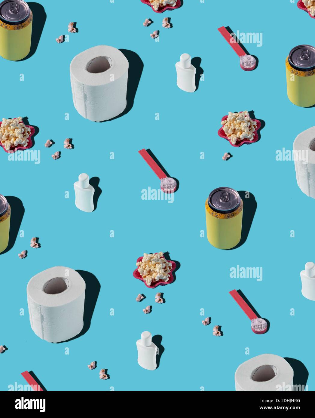 From above of patterns of hygiene supplies and soda cans on blue ...