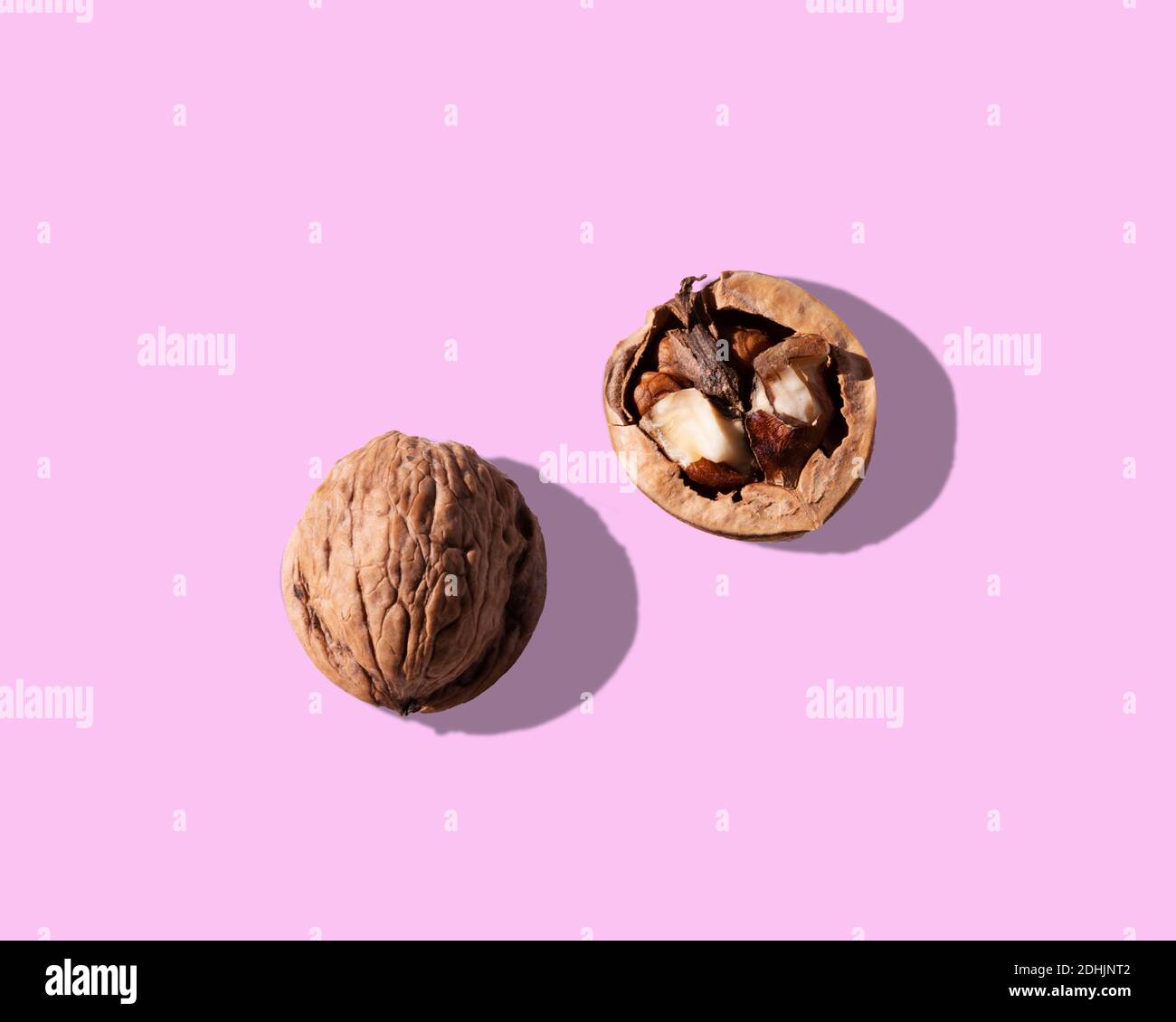 Ripe half peeled walnut at pink background in studio Stock Photo - Alamy