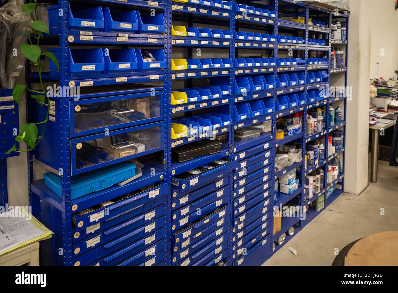 a shelf wall with various spare parts is located in a car workshop ...