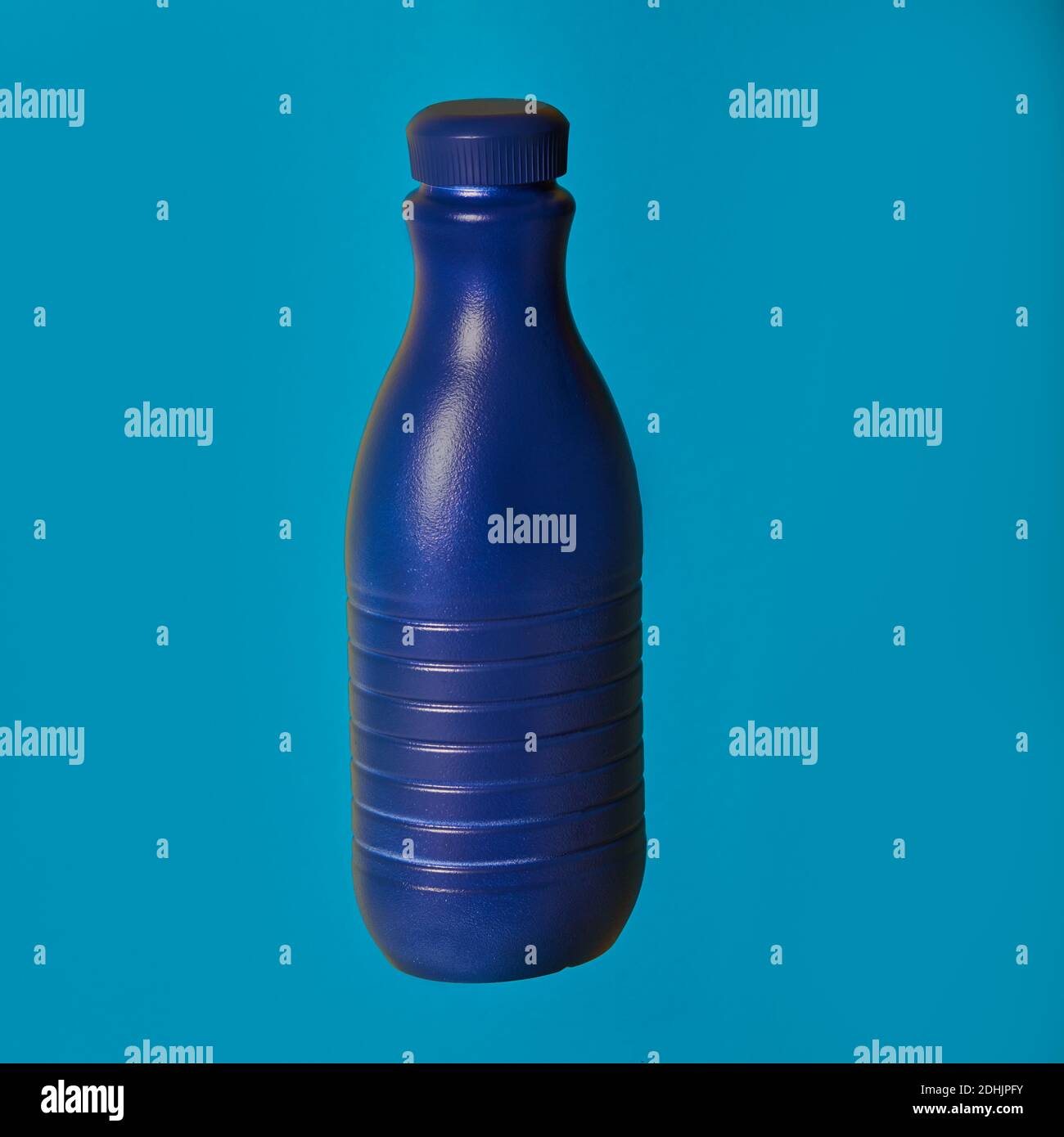 Blue plastic container from liquid detergent placed on vivid blue ...