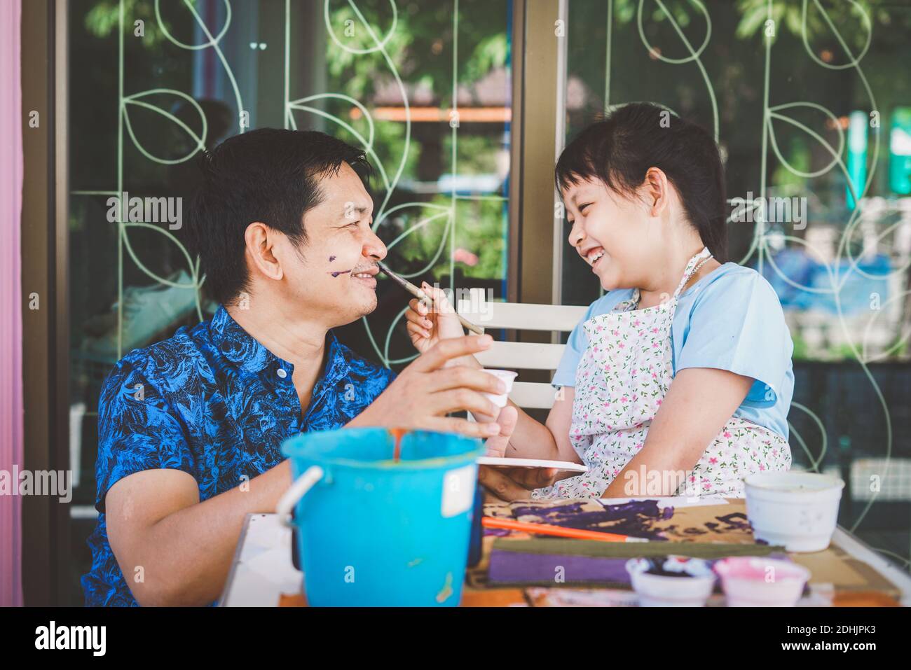 Happy asian Father's day.Funny smiling father and her daughter painting ...