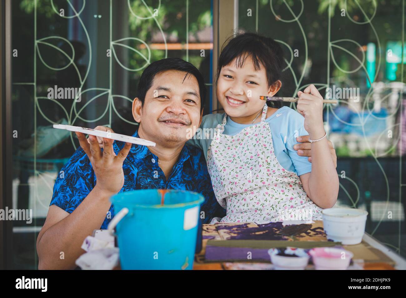 Happy asian Father's day.Funny smiling father and her daughter painting ...