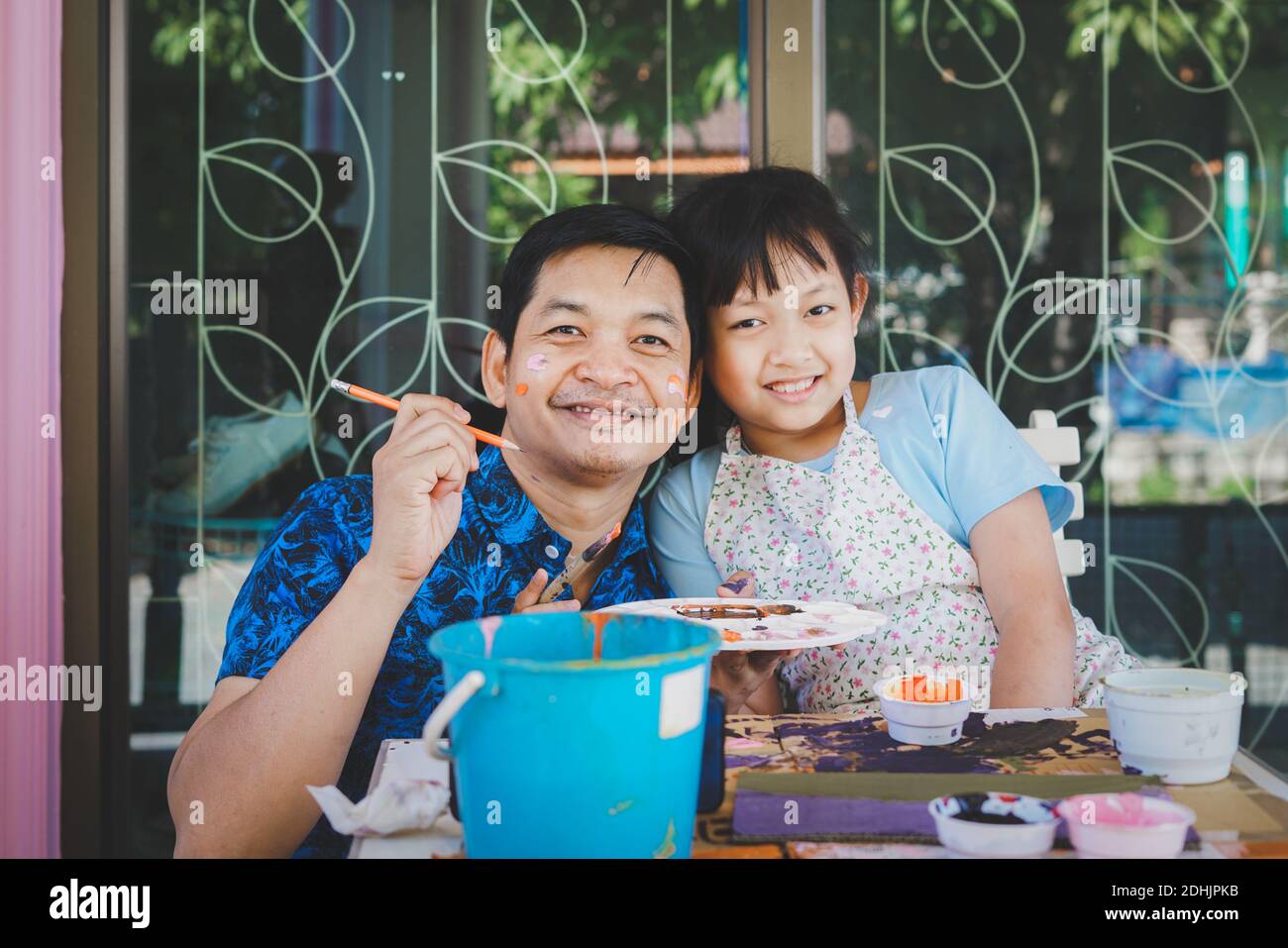 Happy asian Father's day.Funny smiling father and her daughter painting ...