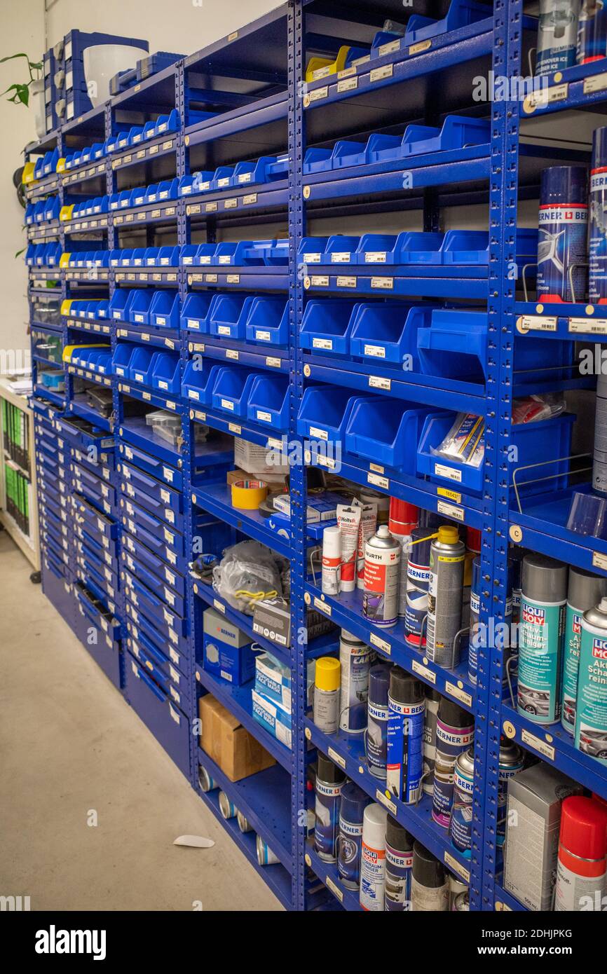 a shelf wall with various spare parts is located in a car workshop ...