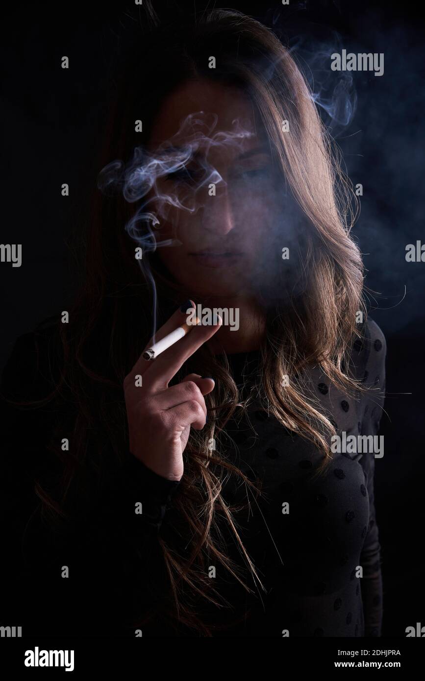 Woman smoking cigarette exhaling tobacco hi-res stock photography and ...