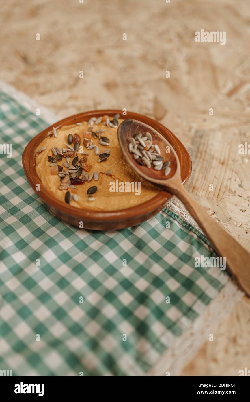 Top view of delicious homemade hummus garnished with rosemary sprig and ...