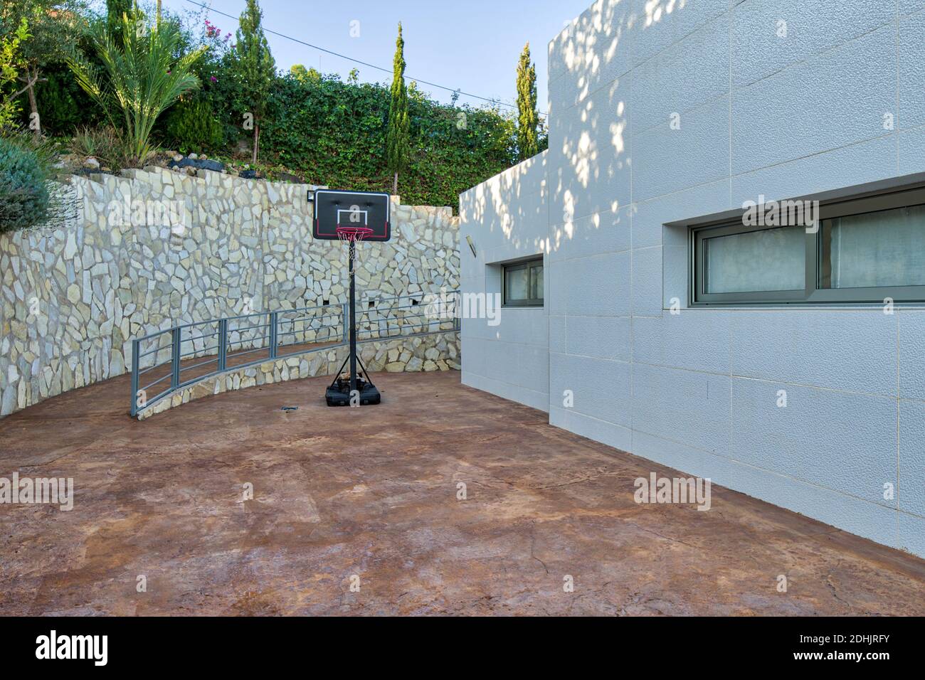 Modern basketball hoop placed in courtyard near contemporary ...