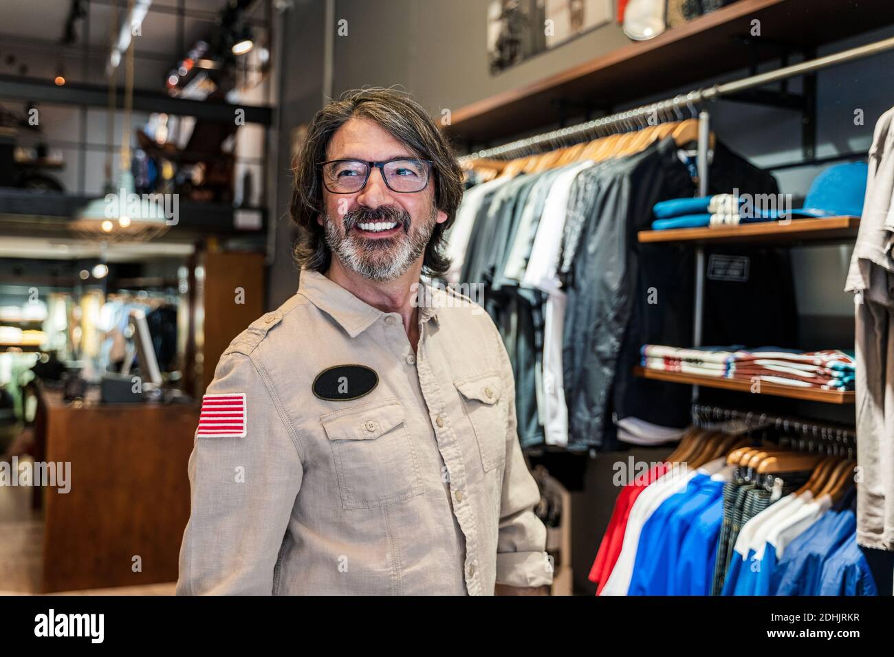 Side view of satisfied customer after buying a shirt in a clothing ...