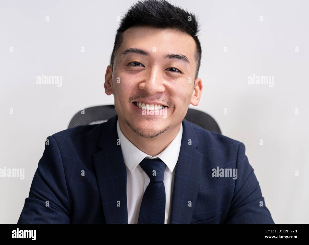 Positive young Asian male executive manager in business style wear ...
