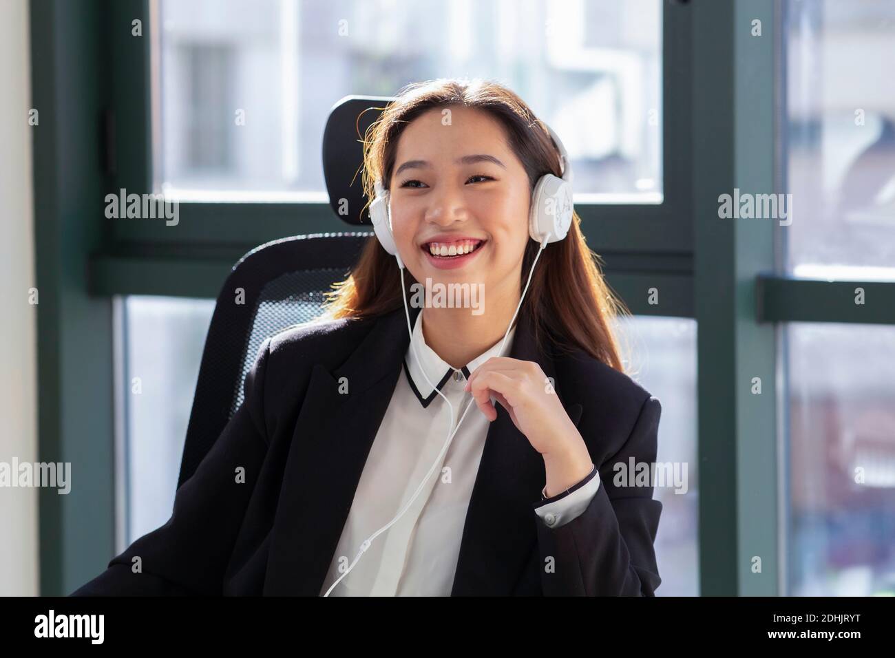 Happy young Asian female office employee in formal outfit and ...