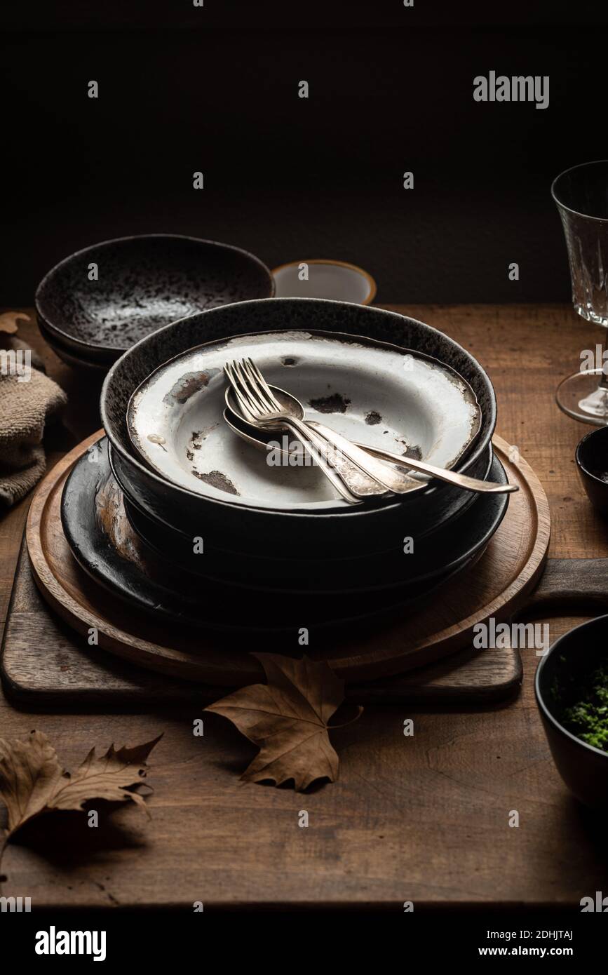 High angle of stack of old fashioned metal plates placed on wooden ...