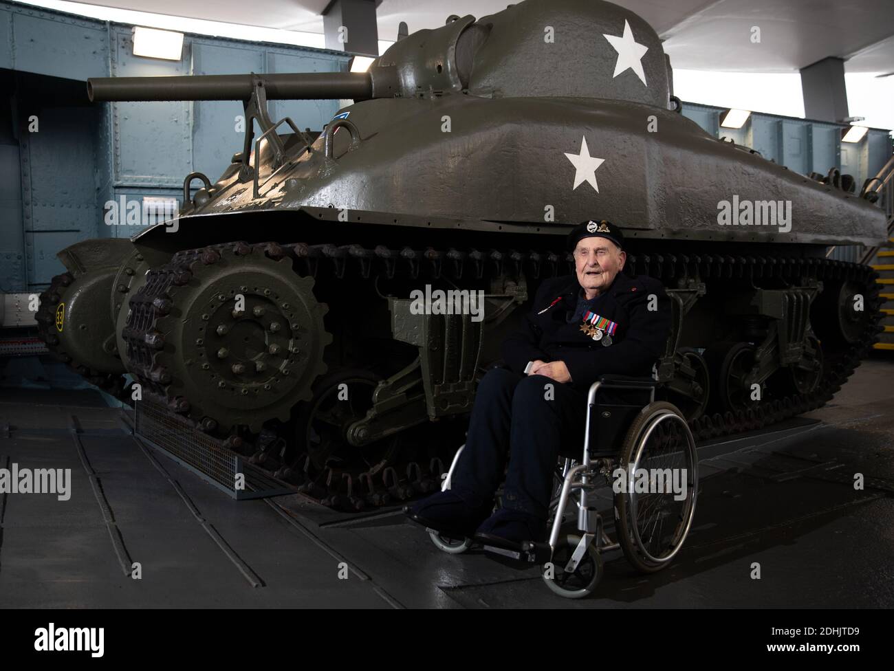 Sherman tank crewman Walter Taylor poses for a photograph in front of a ...