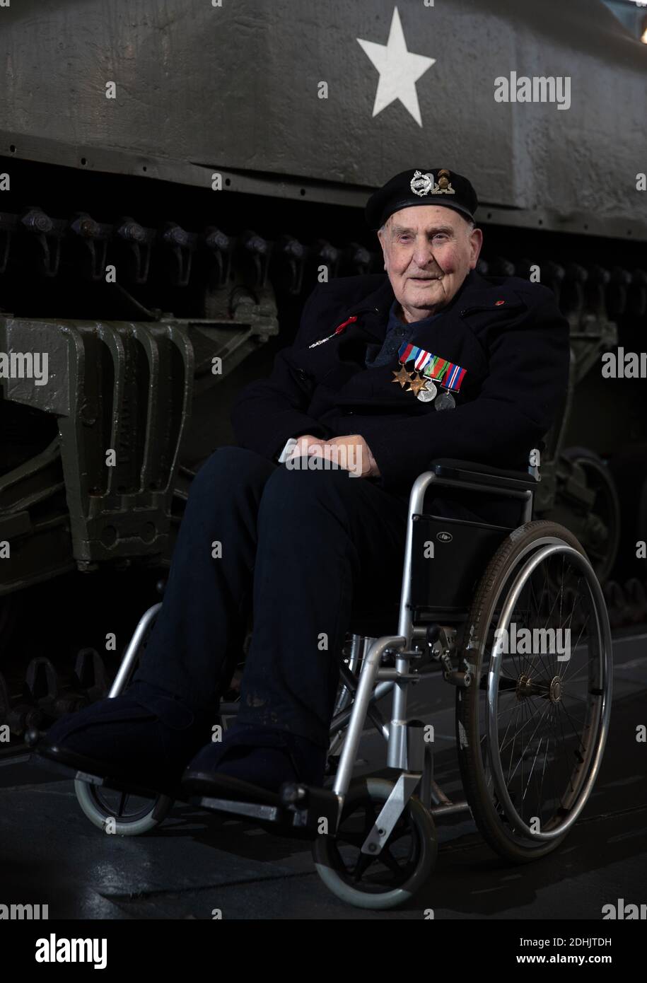 Sherman tank crewman Walter Taylor poses for a photograph in front of a ...
