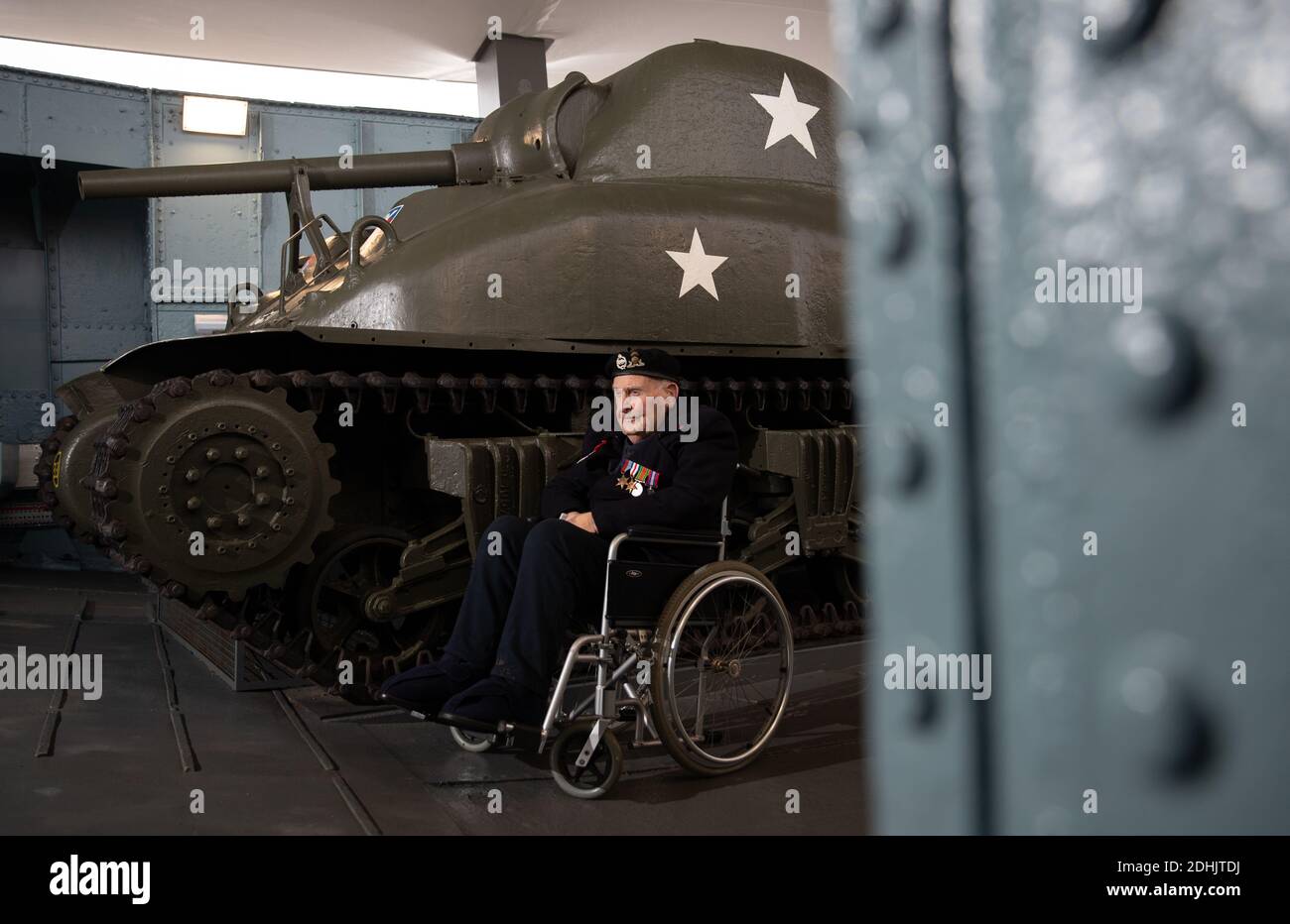 Sherman tank crewman Walter Taylor poses for a photograph in front of a ...