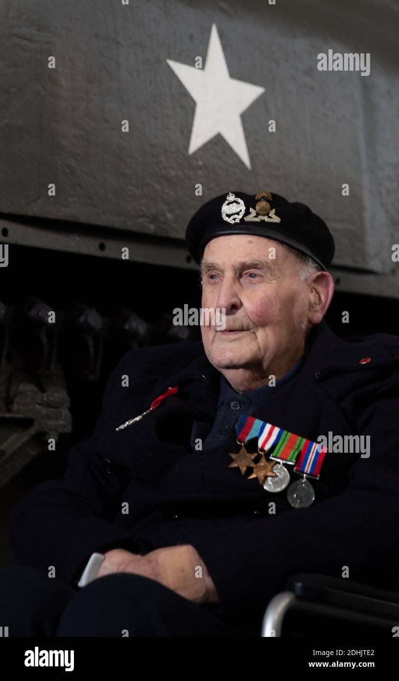 Sherman tank crewman Walter Taylor poses for a photograph in front of a ...