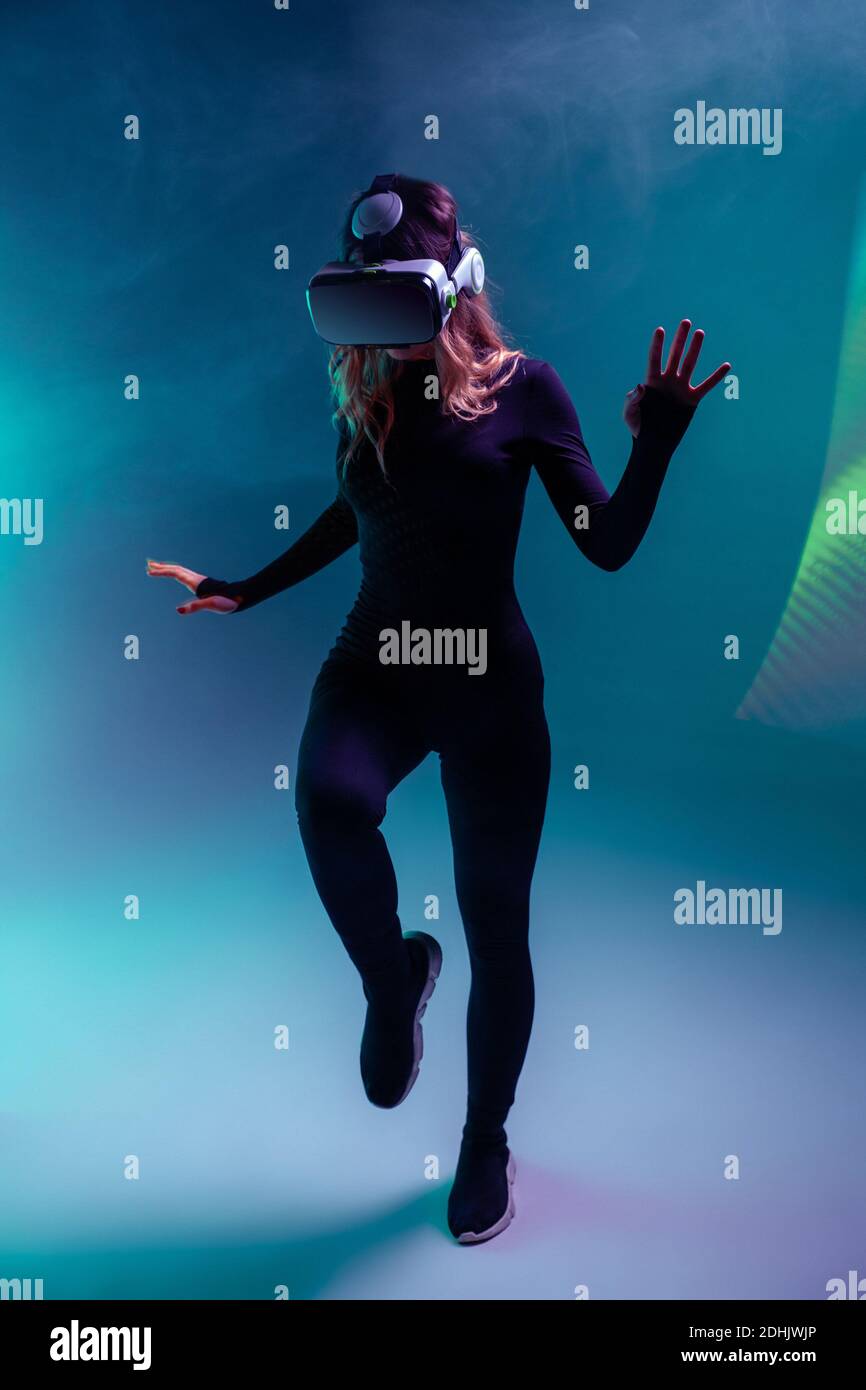 Young unrecognizable blonde Woman jumping touching air and wearing ...