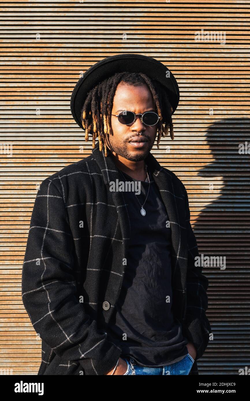 Modern adult black man with dreadlocks wearing hat, sunglasses and ...