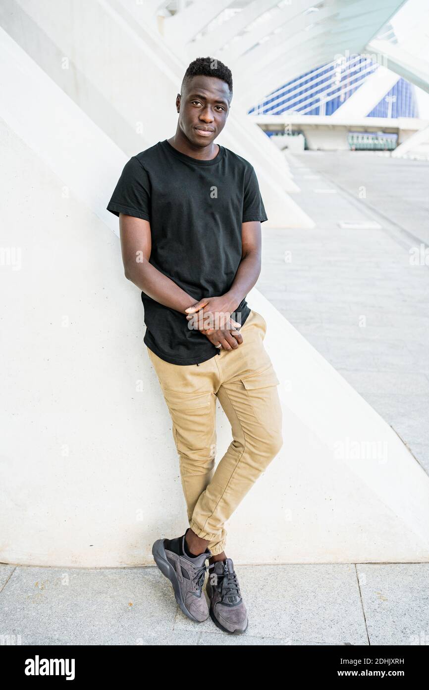 Masculine African American male in casual style clothes standing with ...