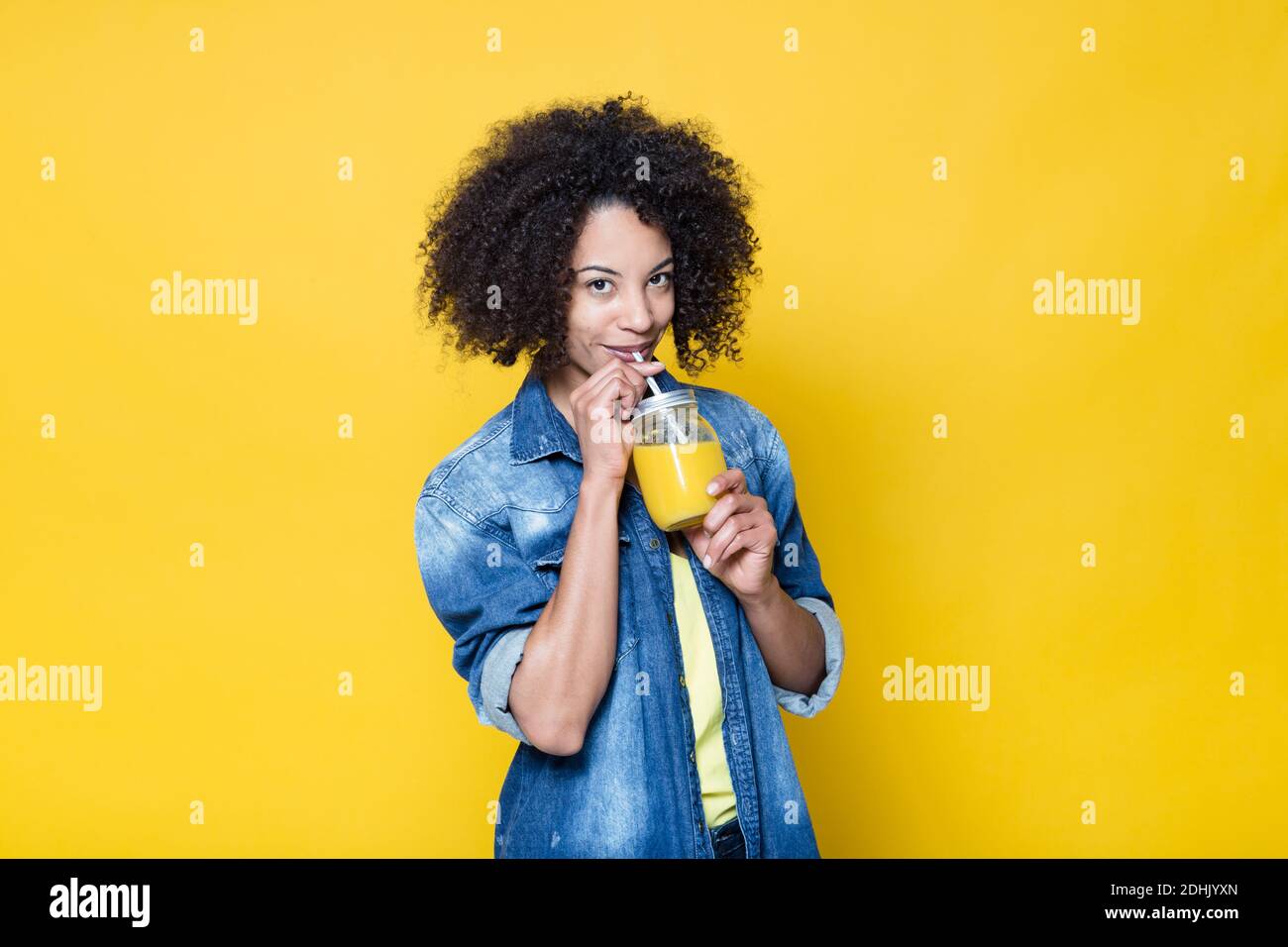 Cheerful Young Curly Haired African American Female In Casual Outfit
