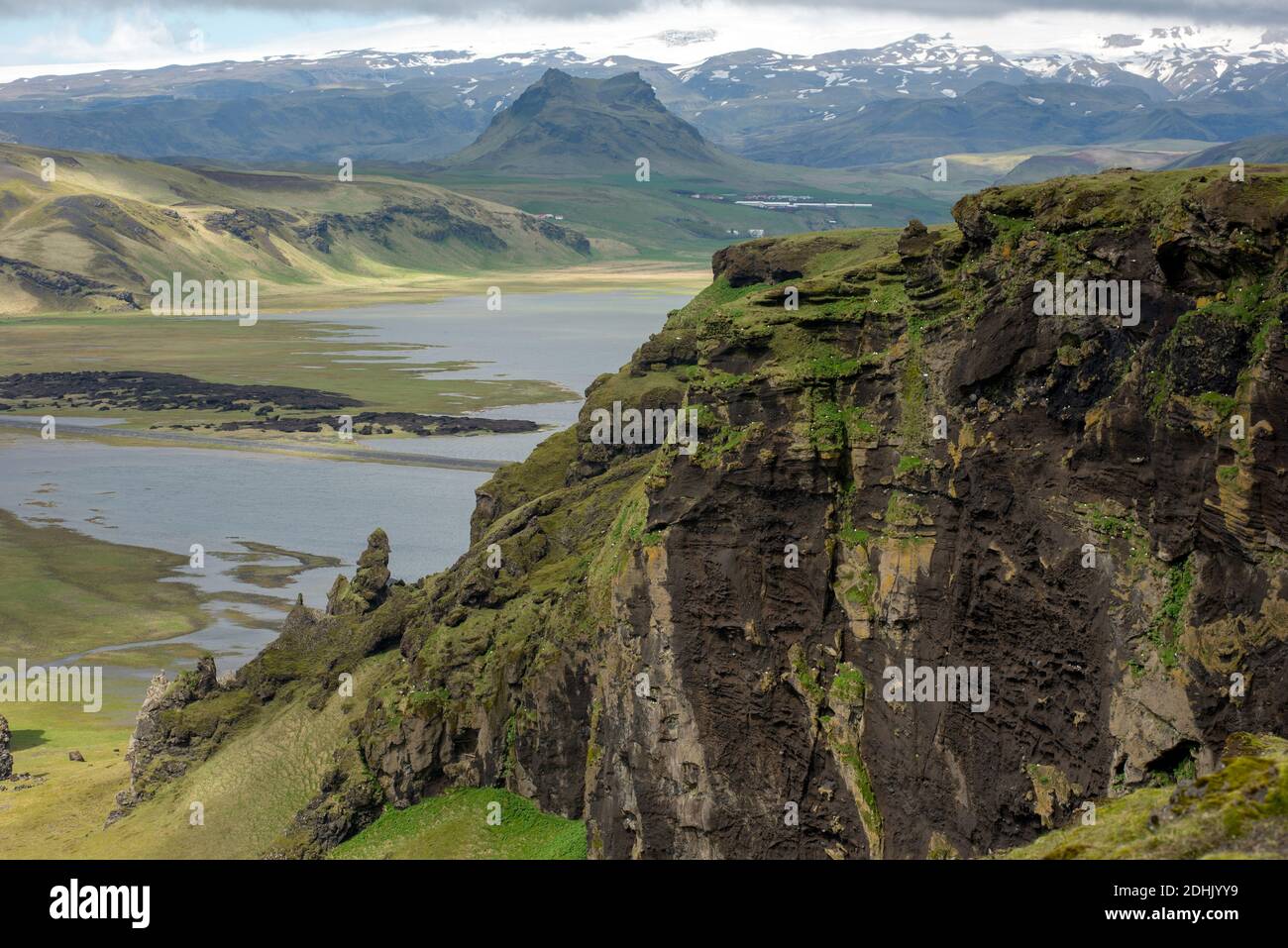 Icelandic landscape with volcanic lava ridge, glacier mountains, green ...