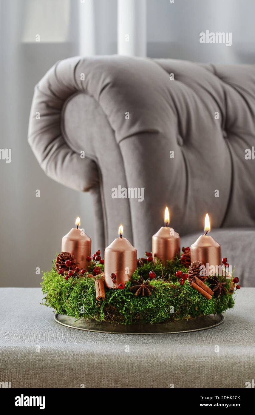 Advent wreath made of moss, cinnamon sticks and rosa canina twigs ...