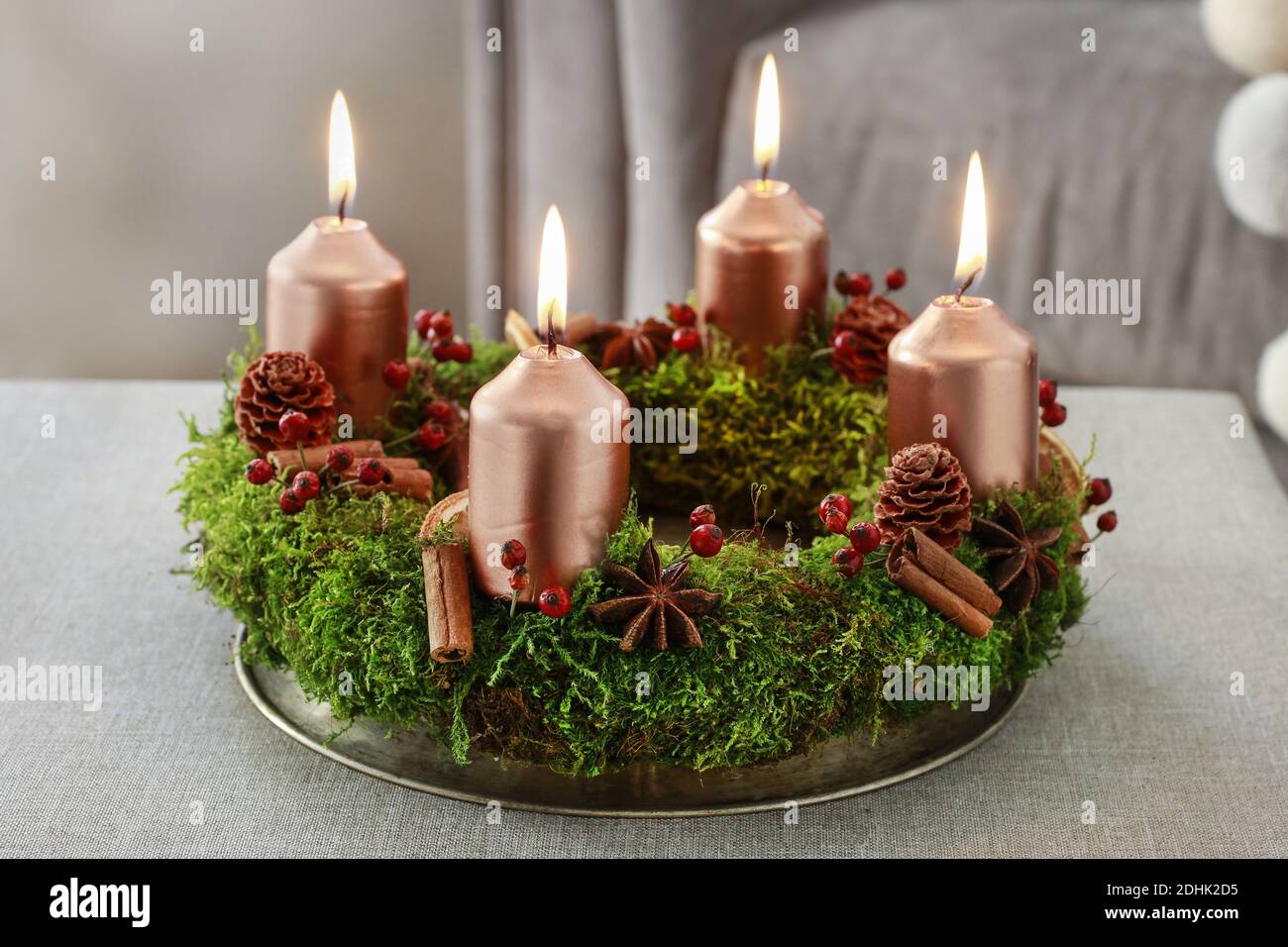 Advent wreath made of moss, cinnamon sticks and rosa canina twigs ...