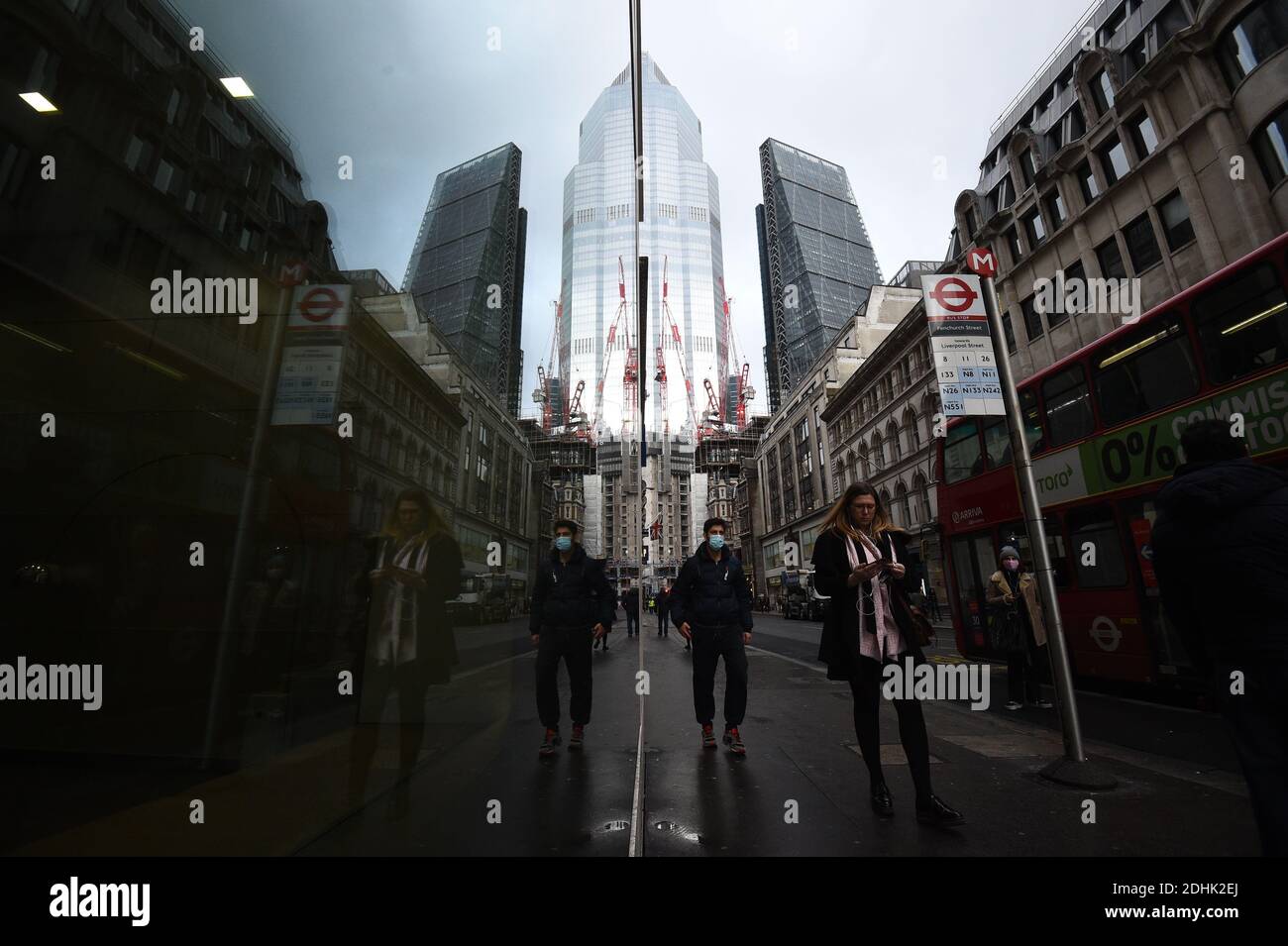 People wearing face masks walk along Fenchurch Street in the City of ...