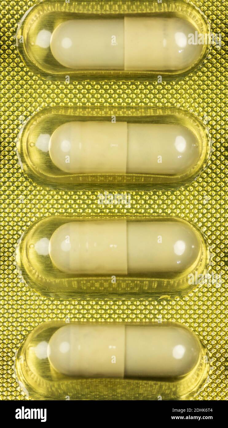 A top view shot of medical yellow capsules - concept of new normal ...