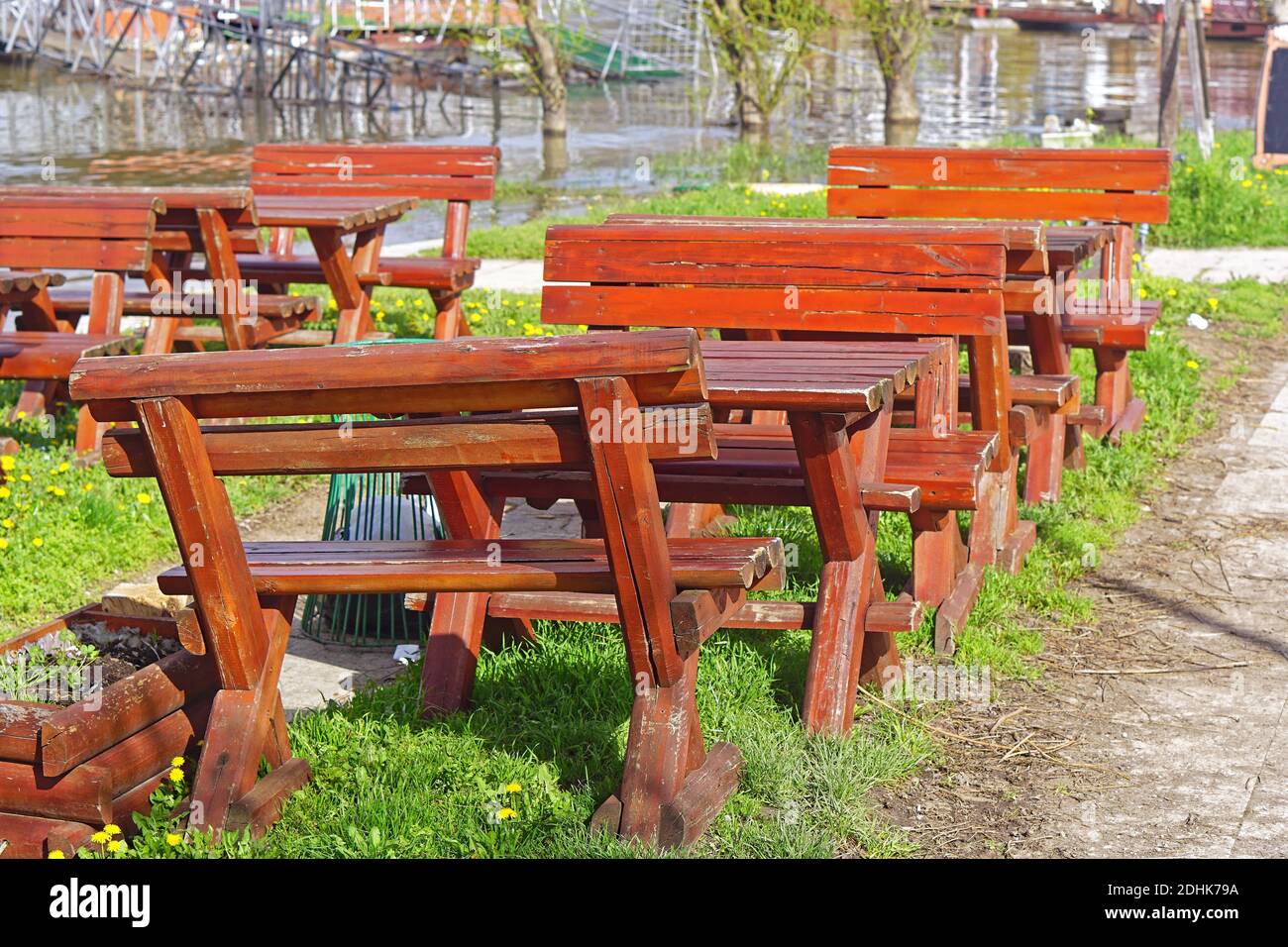 Wooden tables and benches at garden grass Stock Photo - Alamy