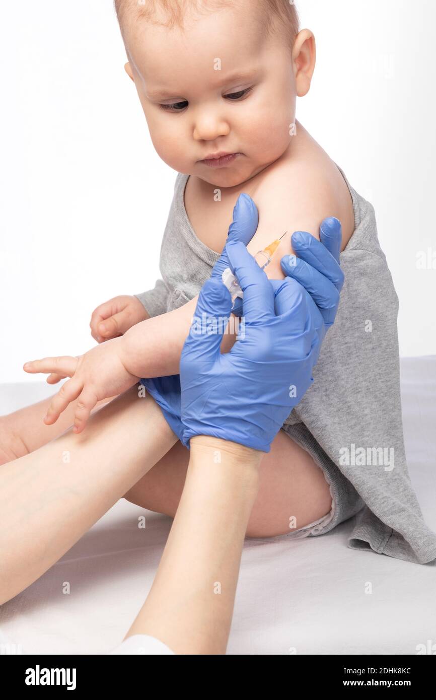 Pediatrician giving baby girl vaccination hi-res stock photography and ...