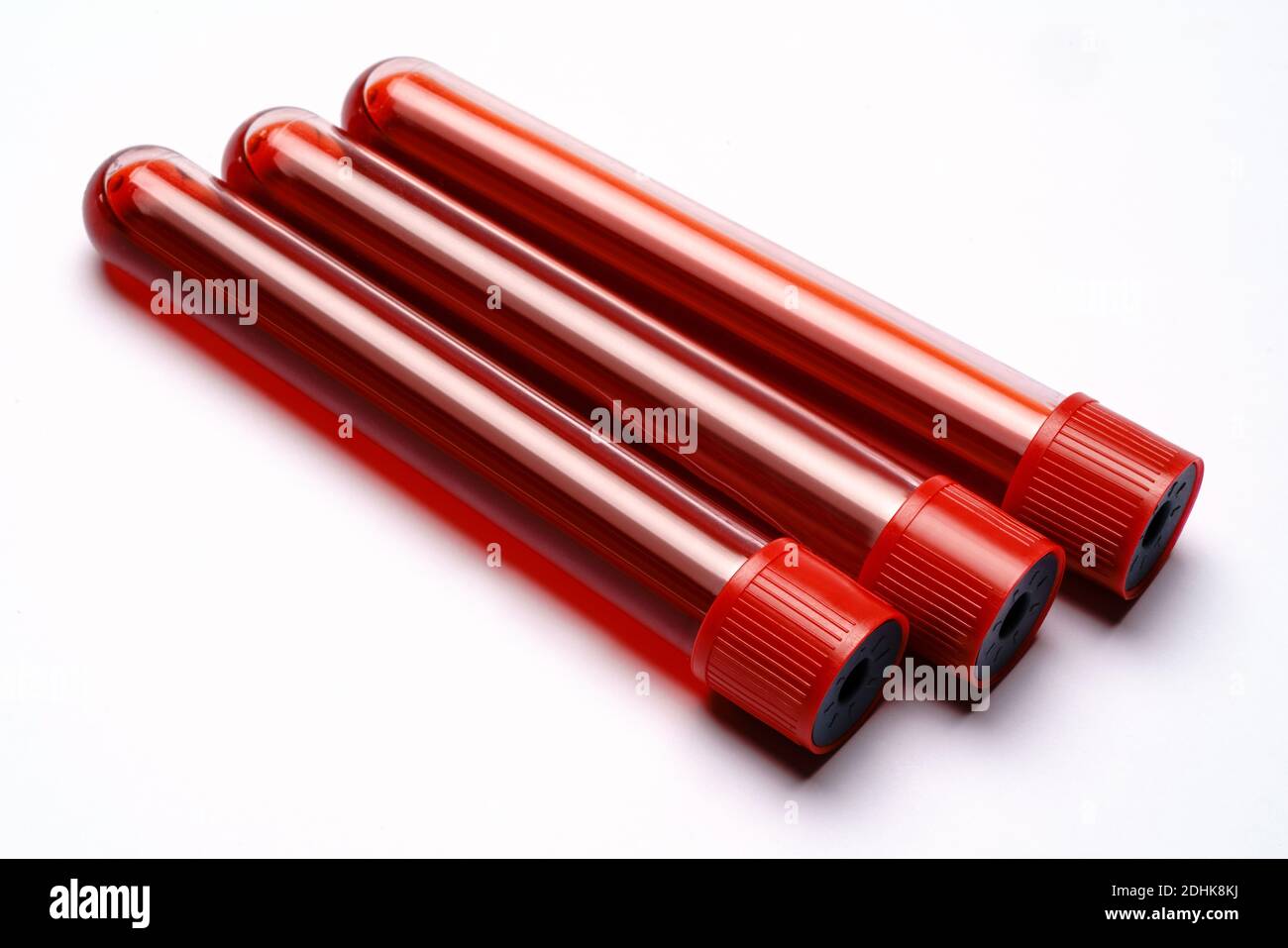 Test tubes with red plug isolated on white background Stock Photo - Alamy