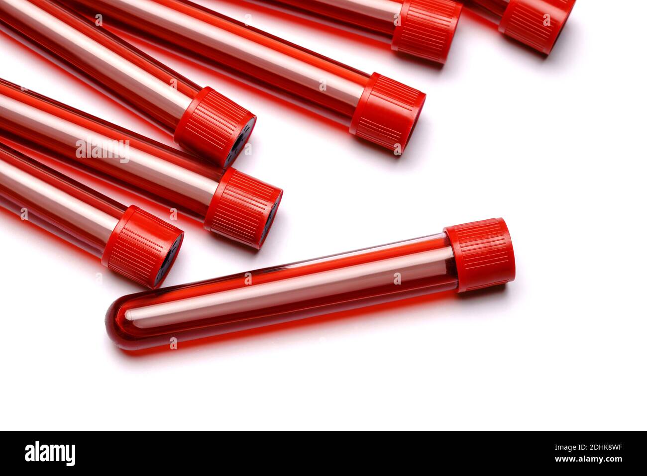 Test tubes with red plug isolated on white background Stock Photo - Alamy