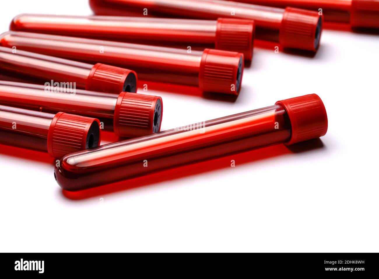 Test tubes with red plug isolated on white background Stock Photo - Alamy