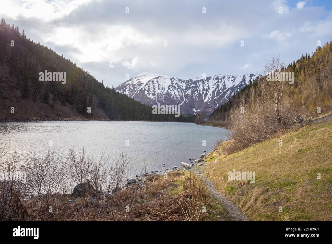 A beautiful shot of a river, high hills, meadow, and high mountains in ...
