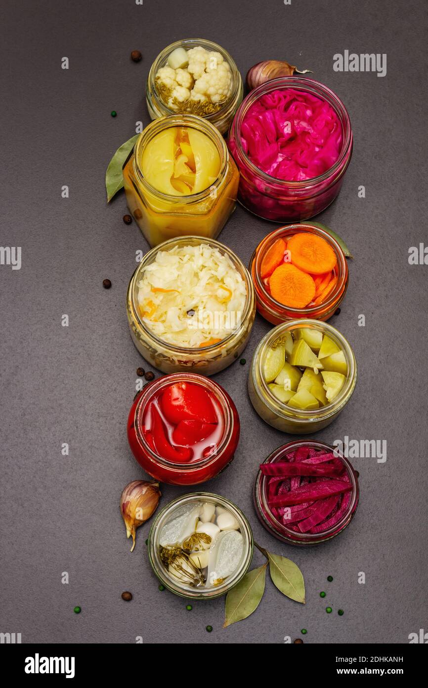 Assorted of fermented vegetables in glass jars. Preserved season ...