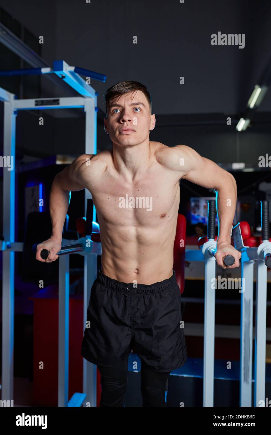 Fitness, sport and people concept - young man doing triceps exercise ...