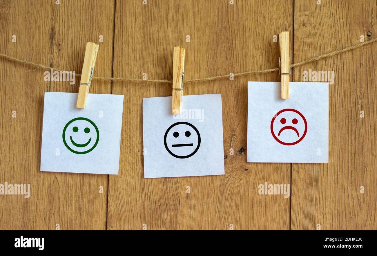 Quality and feedback symbol. Various emoticons made of paper drawn ...