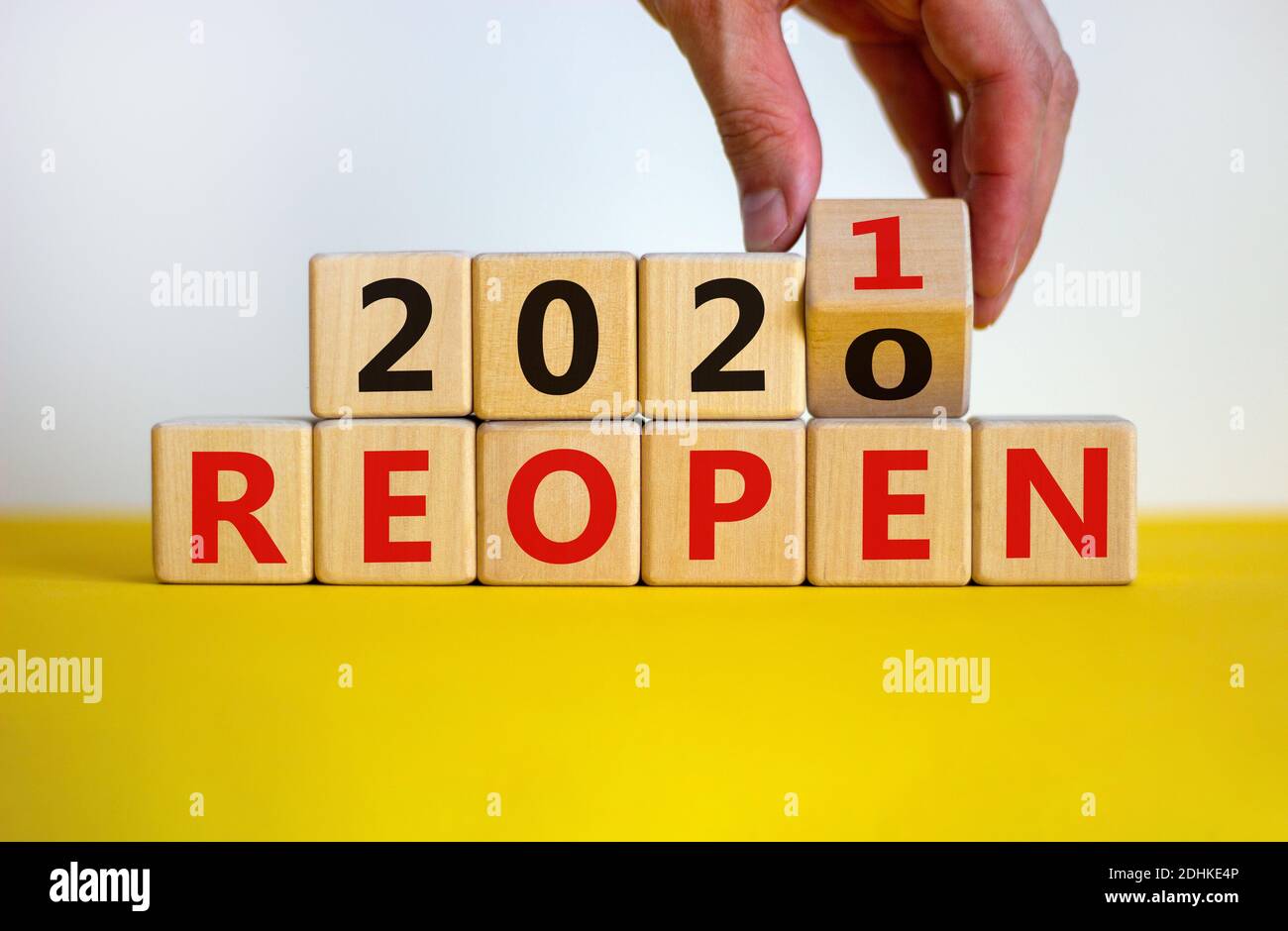 2021 new year reopen symbol. Male hand flips wooden cube and changes ...