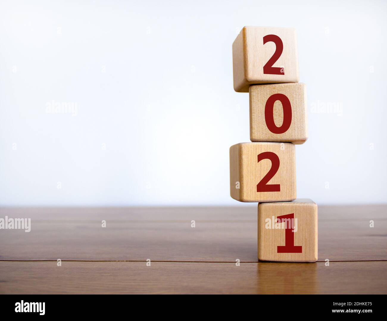 2021 new year symbol. The number '2021' on wooden cubes. Two metalic ...
