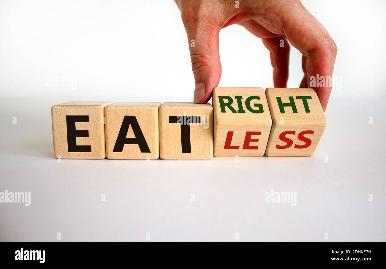 Eat less or right. Male hand flips wooden cube and changes the words ...