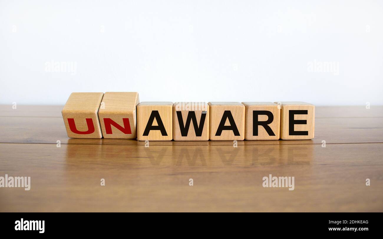 Aware or unaware symbol. Turned a cube and changes words 'unaware' to ...